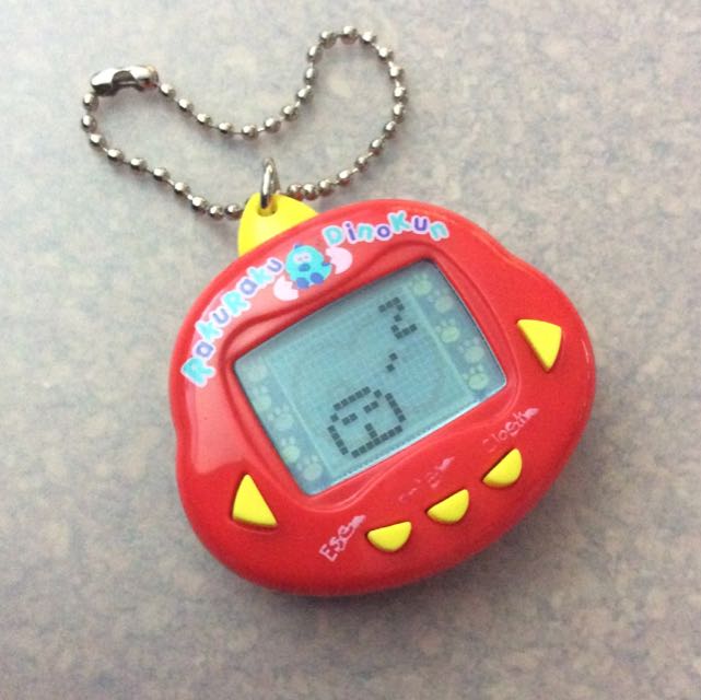 "On Hold" Tamagotchi Raku Raku Dinokun Red, Hobbies & Toys, Toys ...