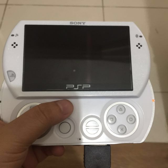 (REPRICED) PSP Go with jelly case with lots of games inside and box ...