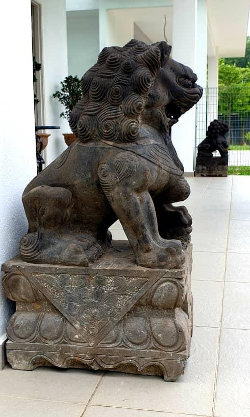 A pair of extremely heavy granite foo dogs ..old pieces antique ...