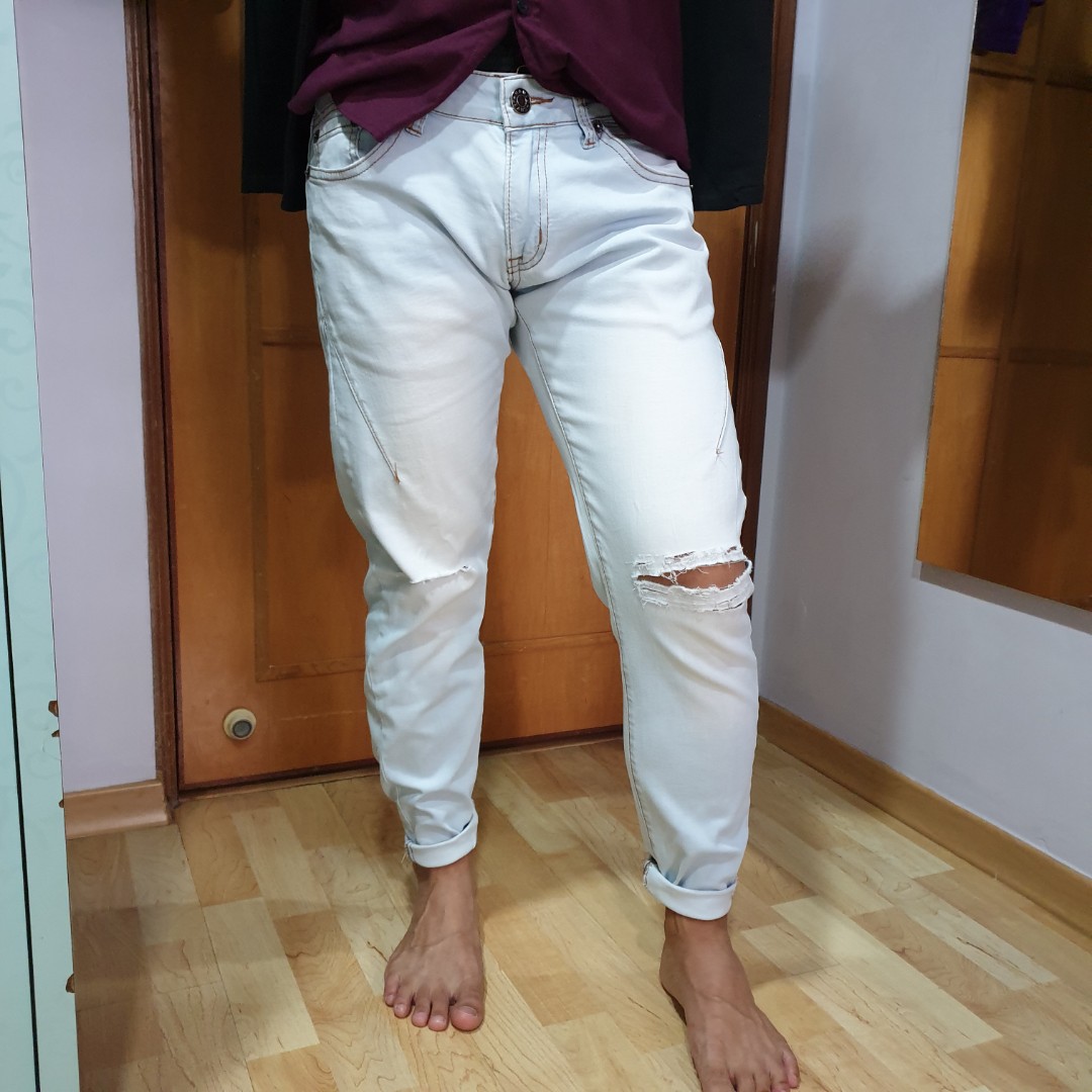 Light blue ripped jeans, Men's Fashion, Bottoms, Jeans on Carousell