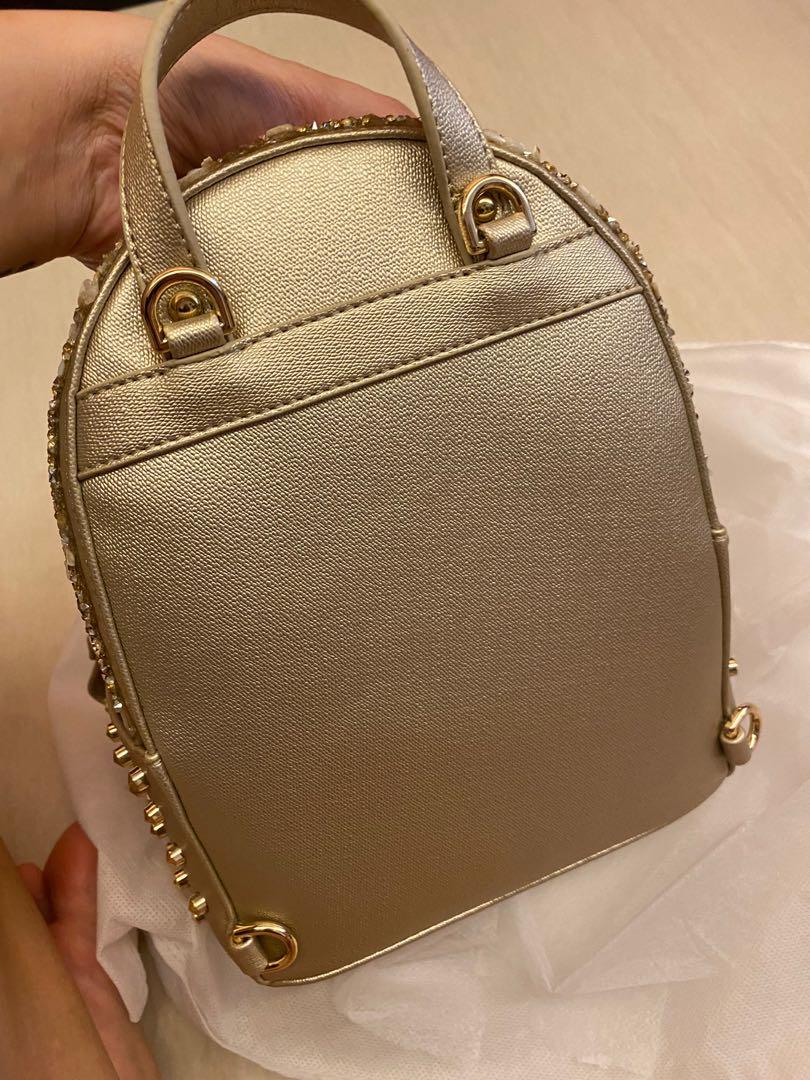 Gold mini backpack, Women's Fashion, Bags & Wallets, Backpacks on Carousell