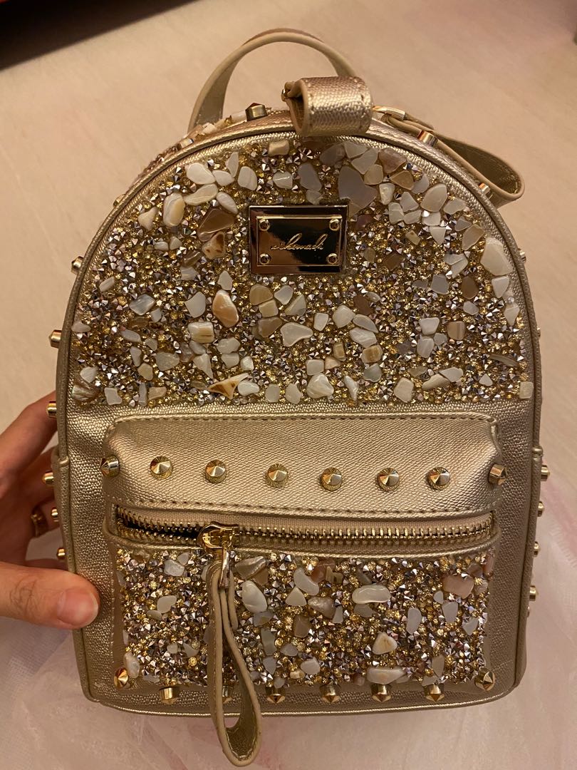 Gold mini backpack, Women's Fashion, Bags & Wallets, Backpacks on Carousell