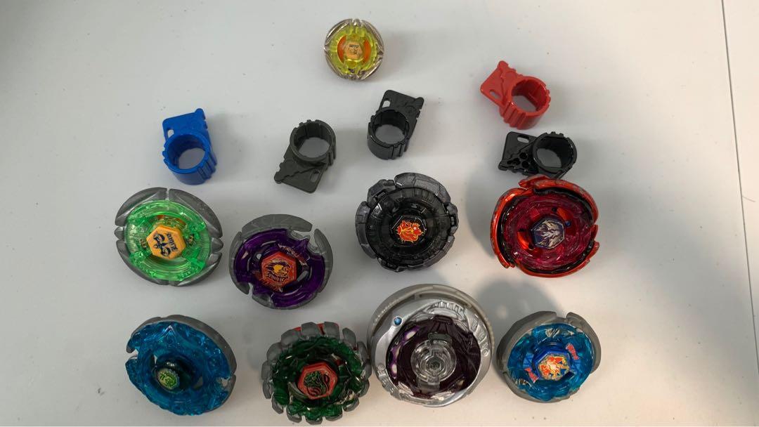 2 Beyblade battle stadiums + 10 beyblade launchers + 8 beyblades + 1 ...
