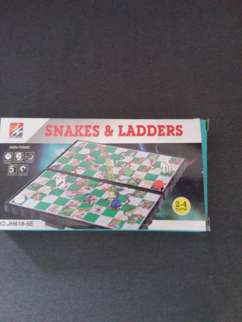 Small snakes and ladders board game with dice and player markers ...