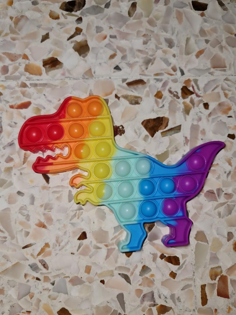 Rainbow dino pop it., Hobbies & Toys, Toys & Games on Carousell