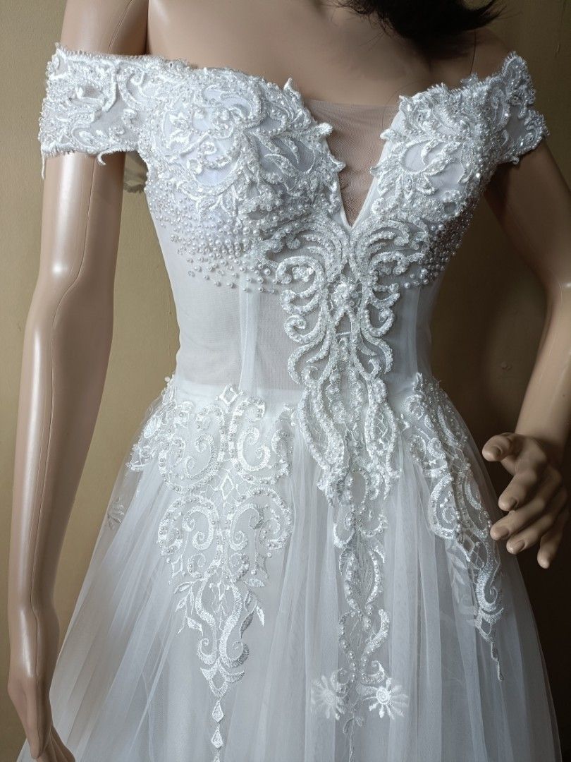 Elegant Beaded Off Shoulder wedding gown with open chest detail and see ...