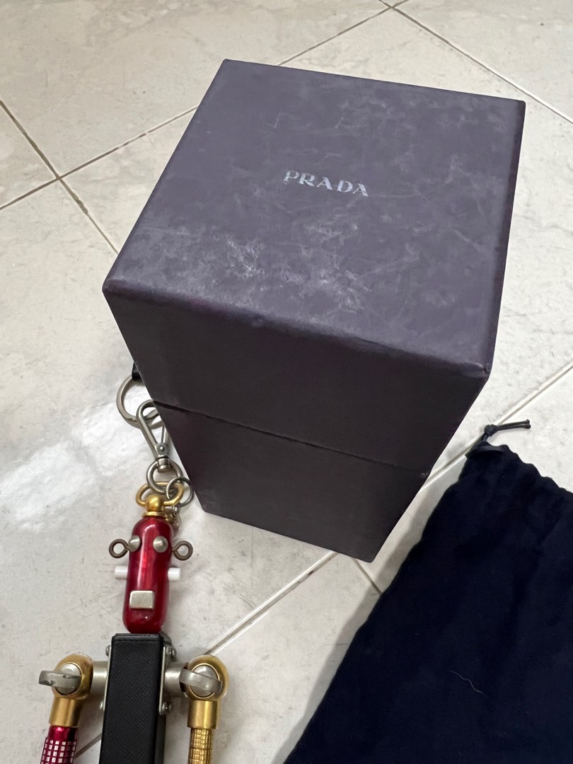 Prada robot keychain, Luxury, Accessories on Carousell