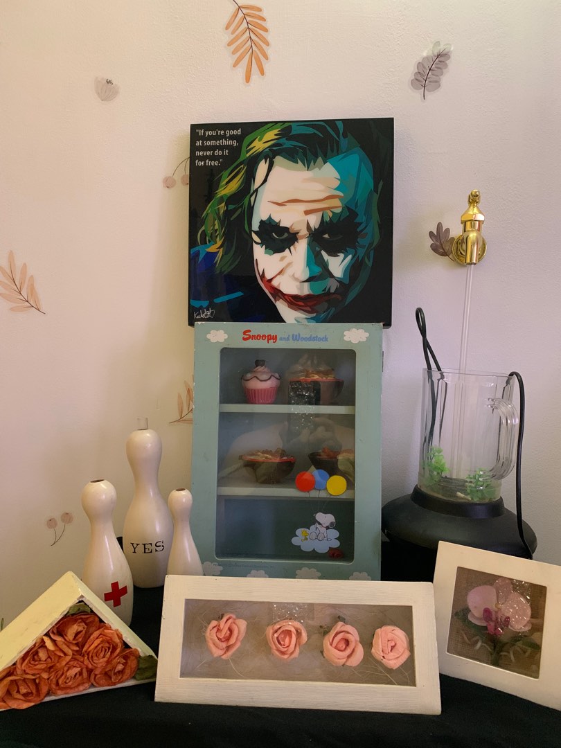 Joker picture, bowling pin vase, water tap fountain, flowers in frame ...