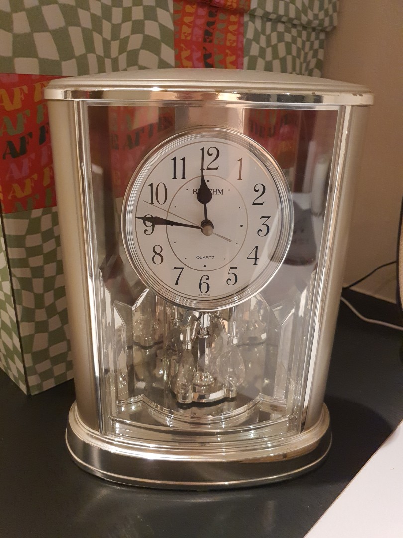 Ornamental clock with rotating glass clockwork (below clock face ...