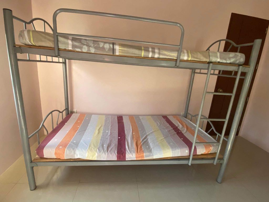 Double deck frame including mattresses and plywood underneath ...