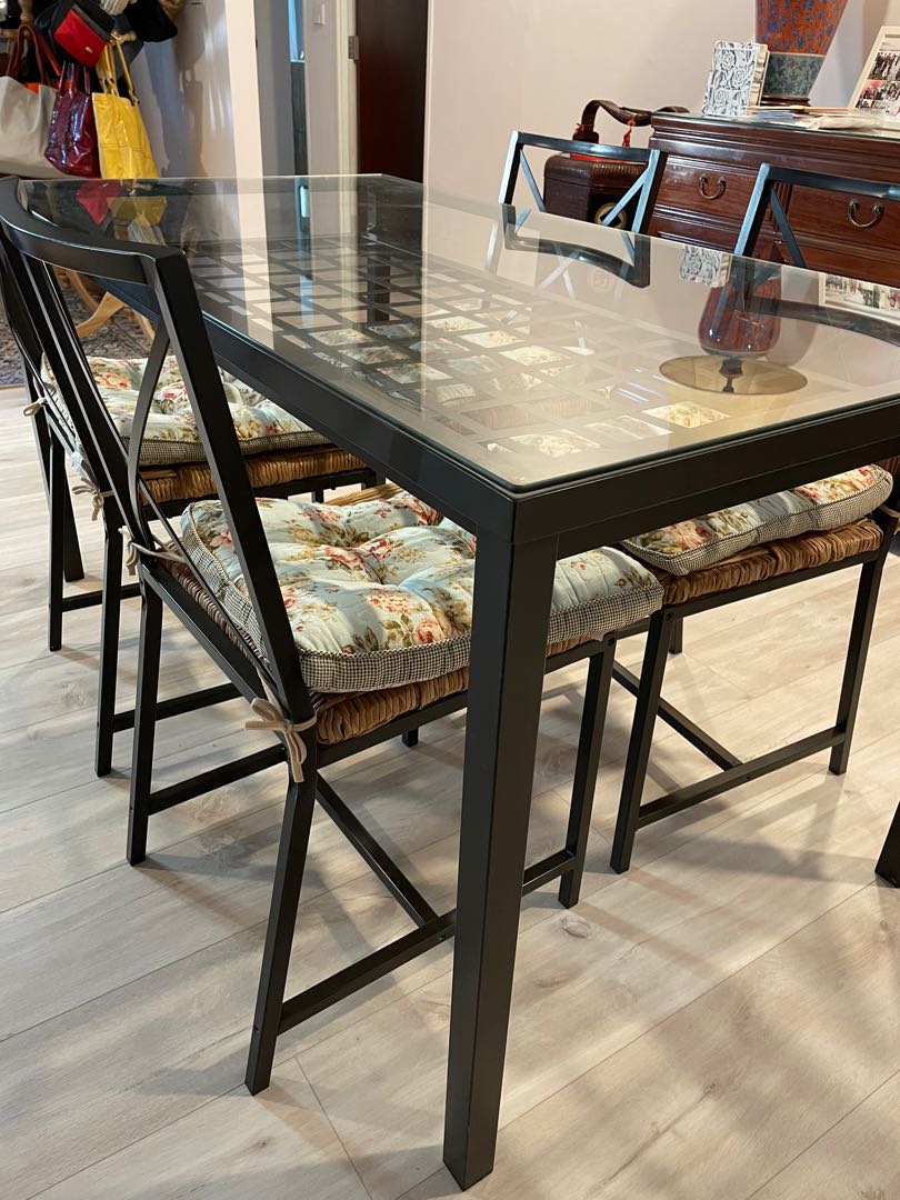 Metal glass dining table with matching chairs and cushions, Furniture ...