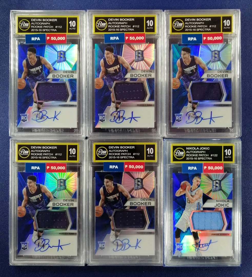 Devin Booker and Nikola Jokic Rookie Patch Autograph RPA NBA Cards on a ...