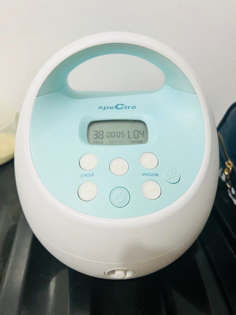 Spectra electric pump with milk storage bottles, flanges, and ice packs ...