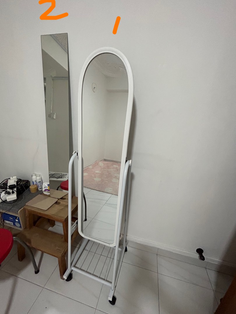 Full length white frame mirror standing movable roller w racks below ...