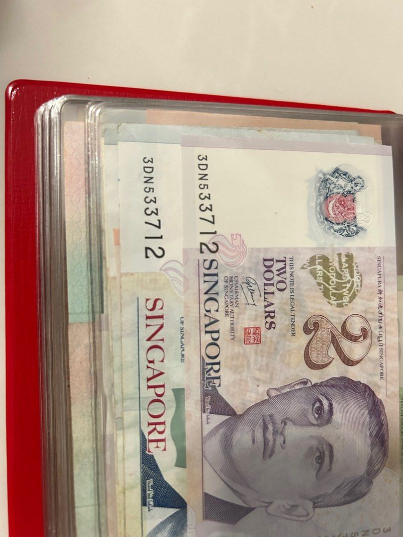Exact same letter and numbers, Singapore $2 and $50 currency notes ...