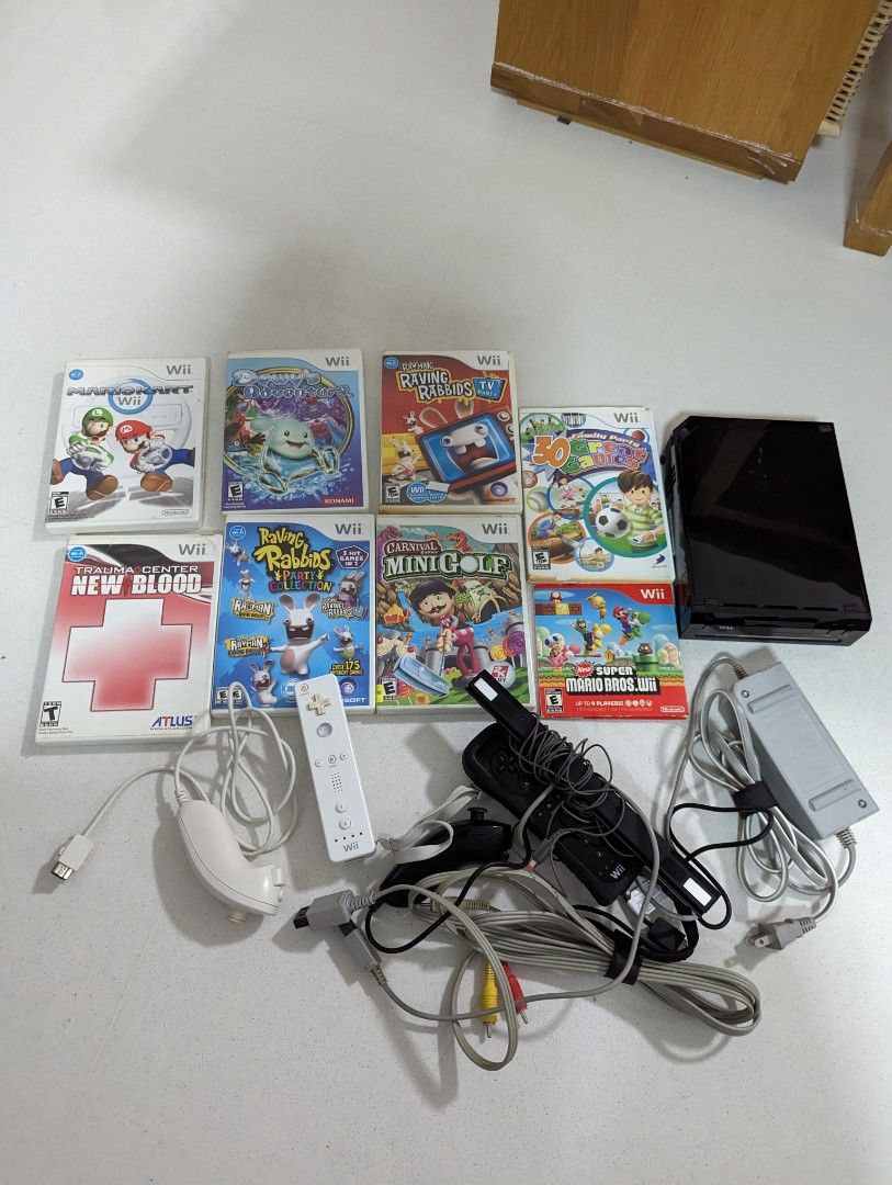 Wii console with 2 set of wiimot and nunchuck and 8 games raving ...