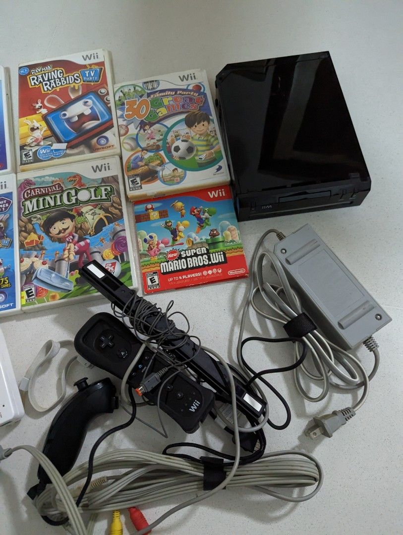 Wii console with 2 set of wiimot and nunchuck and 8 games raving ...
