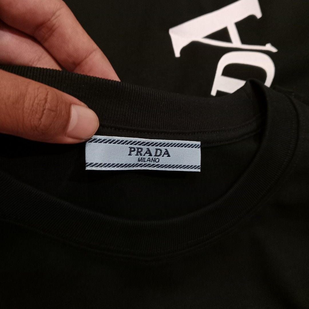 Prada tee, Fesyen Pria, Pakaian , Atasan di Carousell