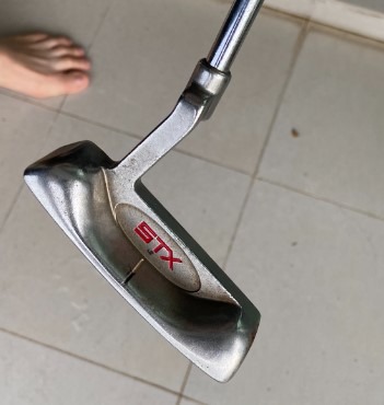 STX putter with original grip and friction enhancing elastomer layer ...