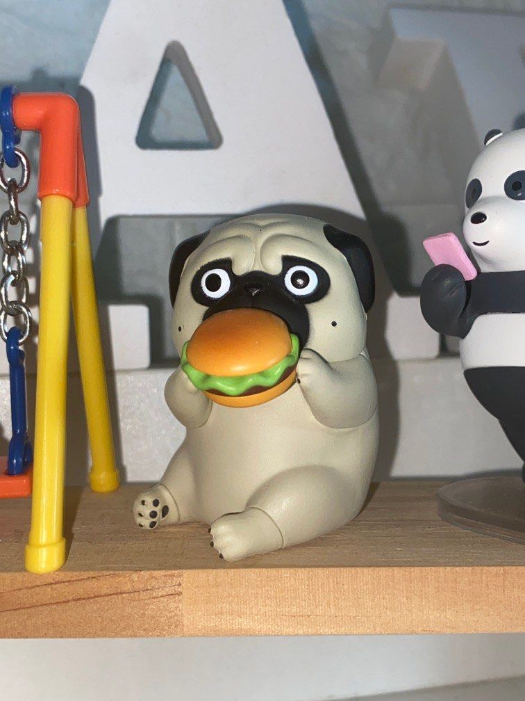 Pug holding burger figurine, Hobbies & Toys, Toys & Games on Carousell