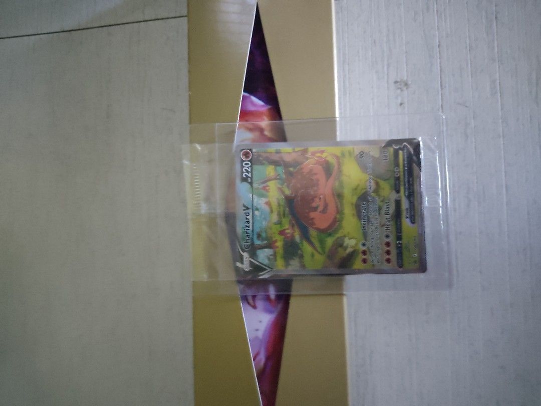 Charizard promo UPCZ and Charizard Vmax game mat on Carousell