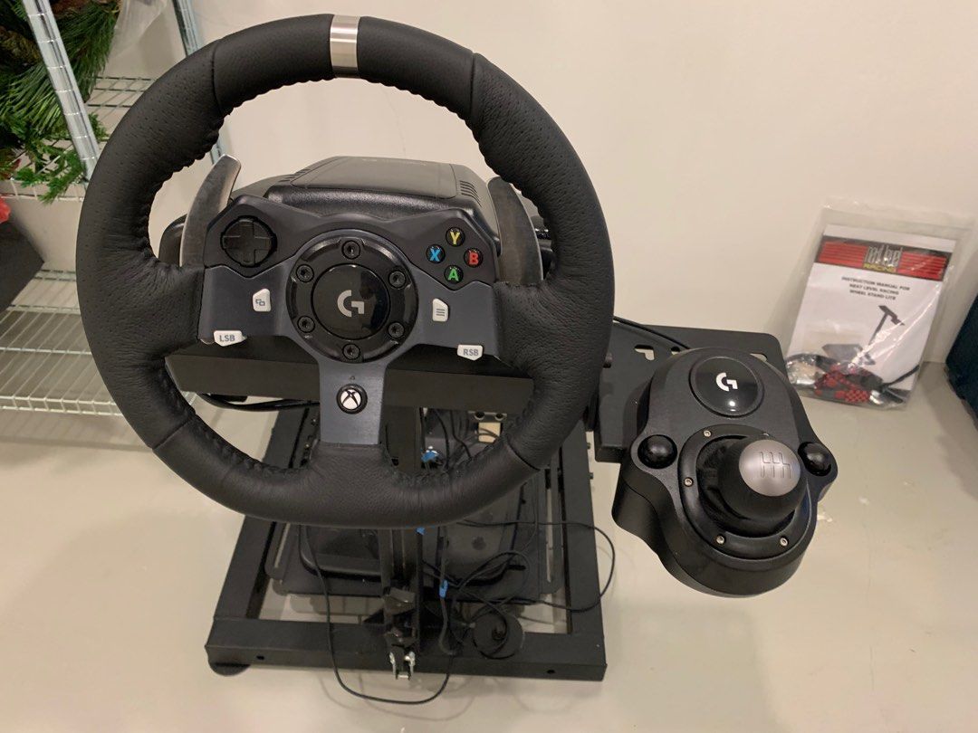 Logitech steering wheel, gear-shifter, and pedal set attached to a Next ...