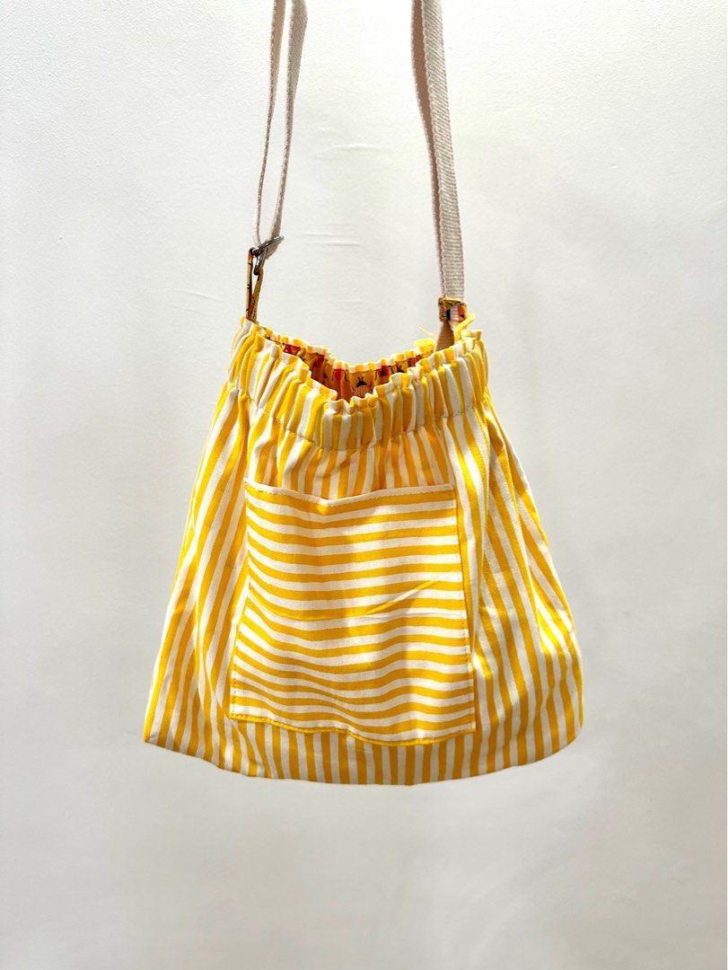 Yellow reversible beetle insect print and striped dumpling sling bag ...