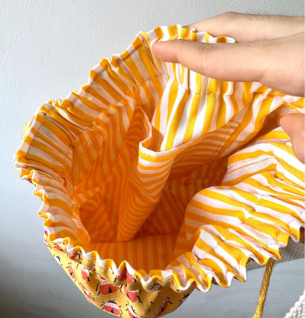 Yellow reversible beetle insect print and striped dumpling sling bag ...