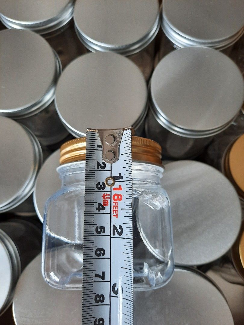 Clear plastic rectangular containers and plastic and metal cylindrical ...