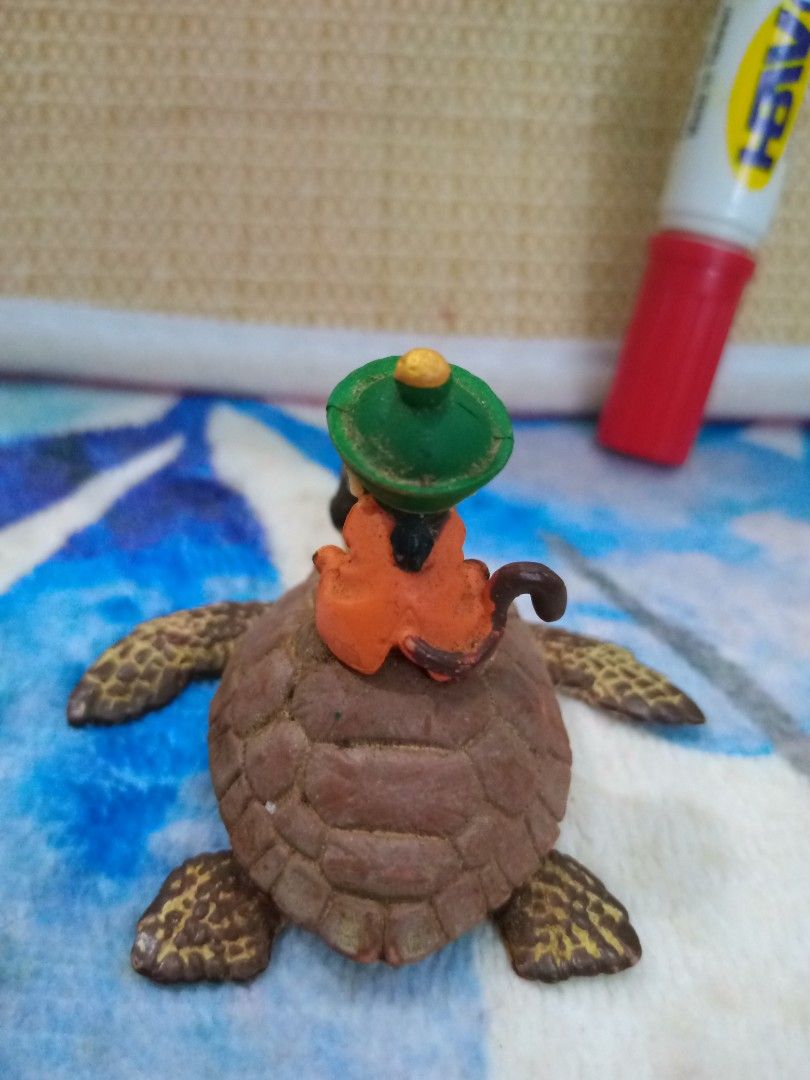 Kid Goku riding in a turtle 120 on Carousell