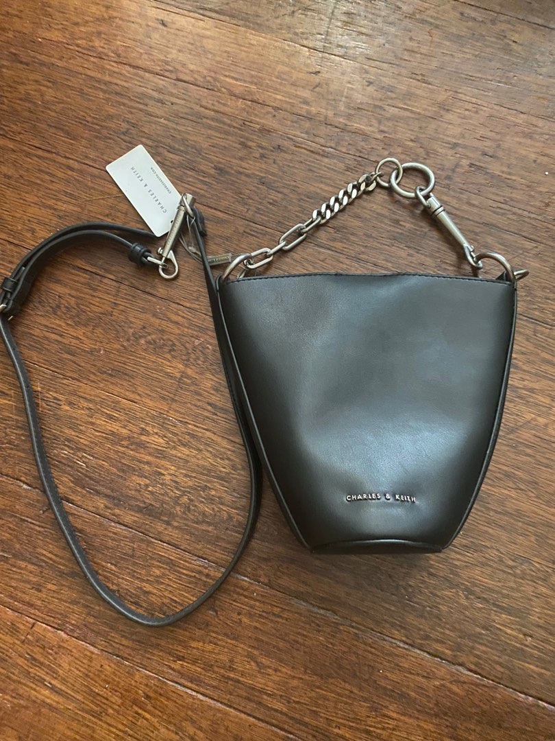 Black mini slanted bucket bag, Luxury, Bags & Wallets on Carousell
