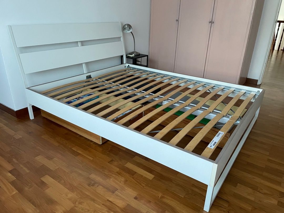 IKEA Wooden frame Queen bed frame with wood slatted. 2 roll-out storage drawers included ...