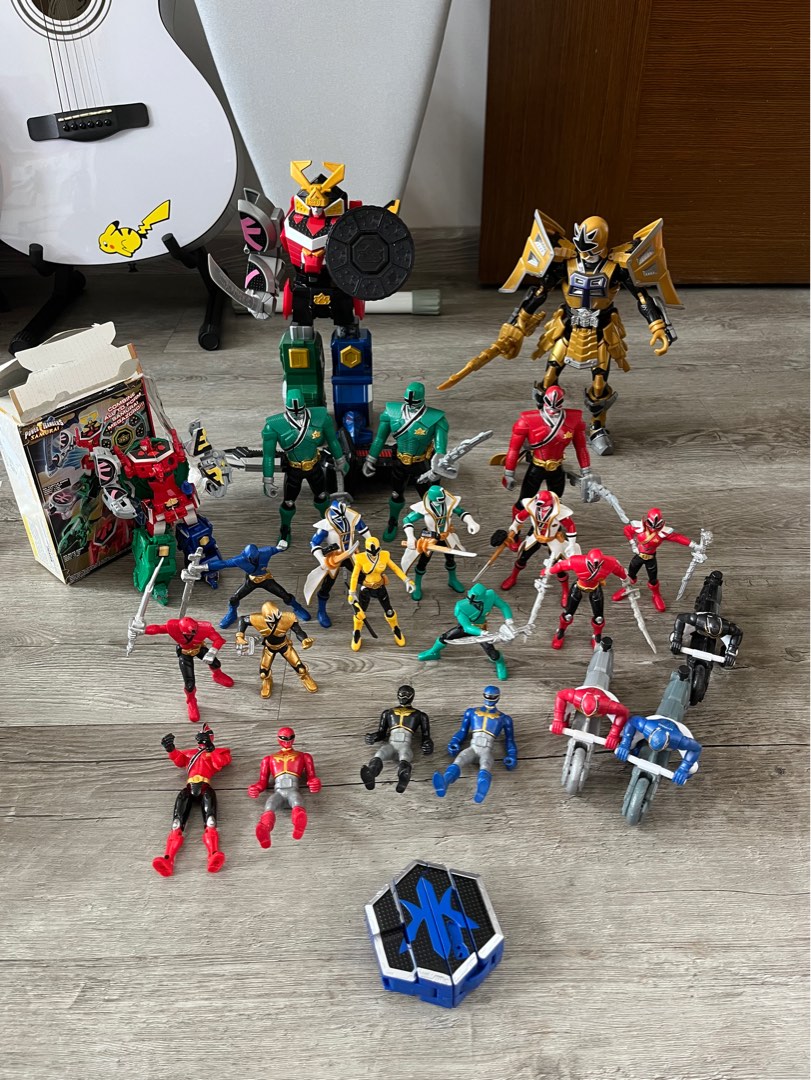 Box full of power rangers, weapons, vehicles, figurines, and extra ...