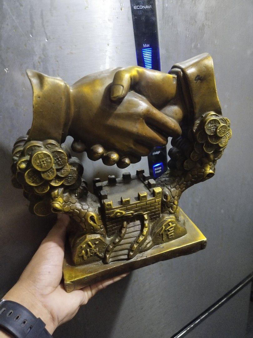 Brass shaking hands statue display on Carousell