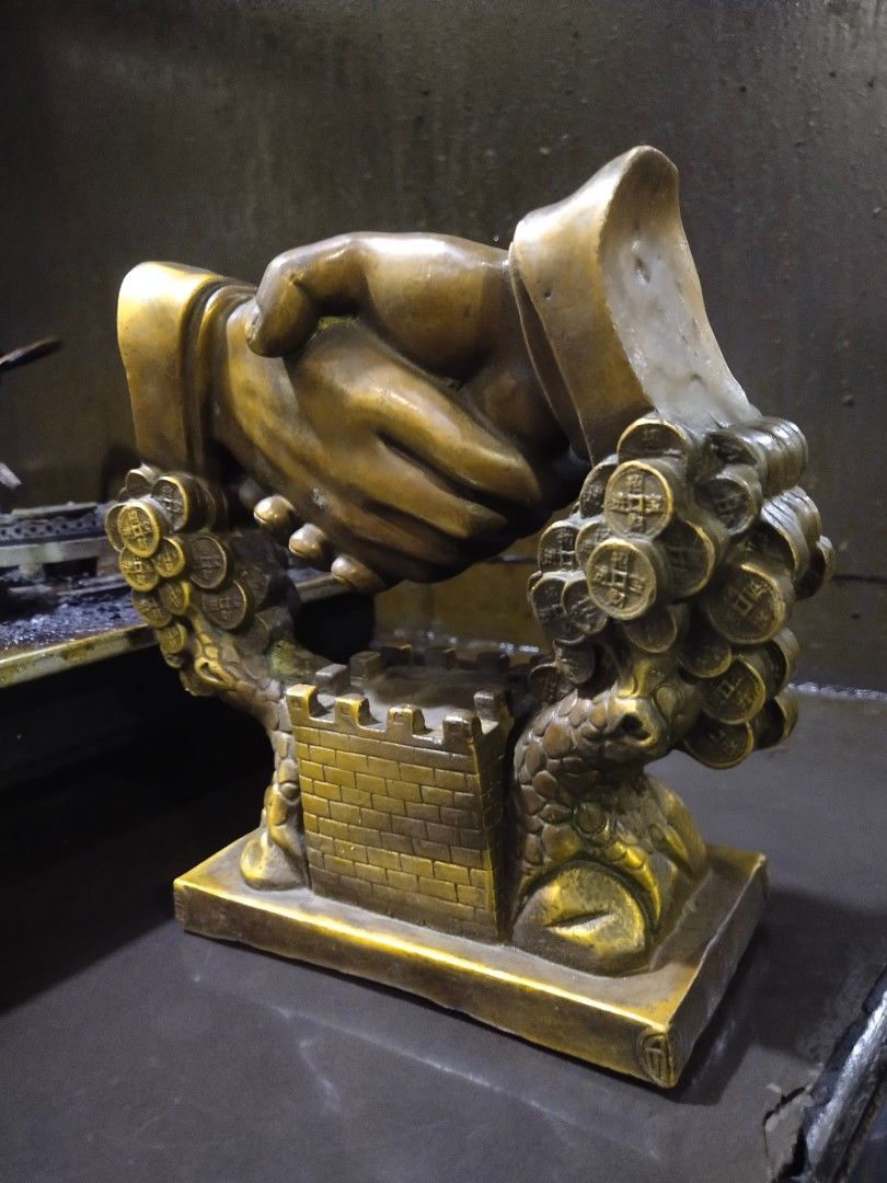 Brass shaking hands statue display on Carousell