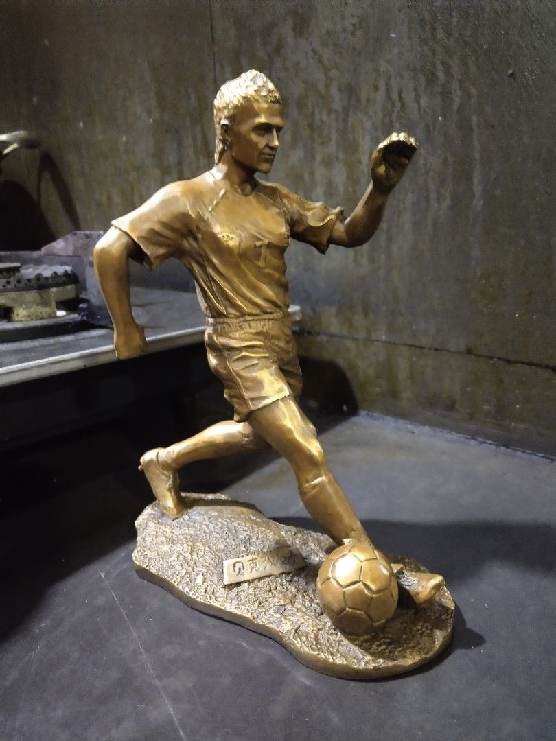 Brass football player statue display on Carousell