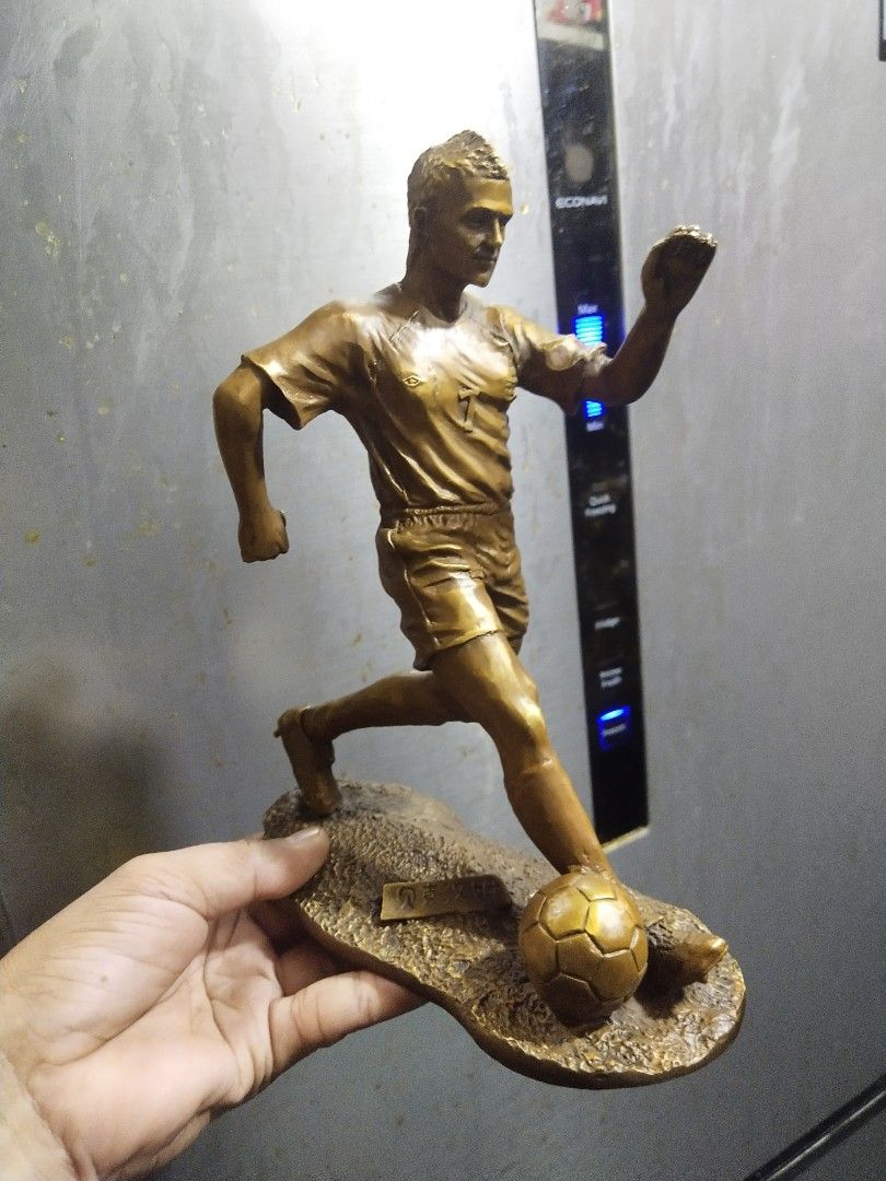 Brass football player statue display on Carousell