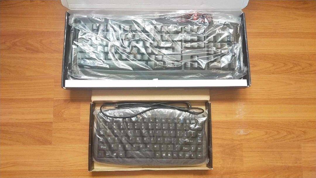 A1 tech and Okion keyboards with boxes on Carousell