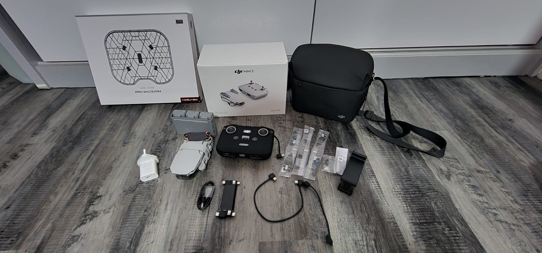 DJI Mini 2 with combo box and added few accessories and protective cage ...