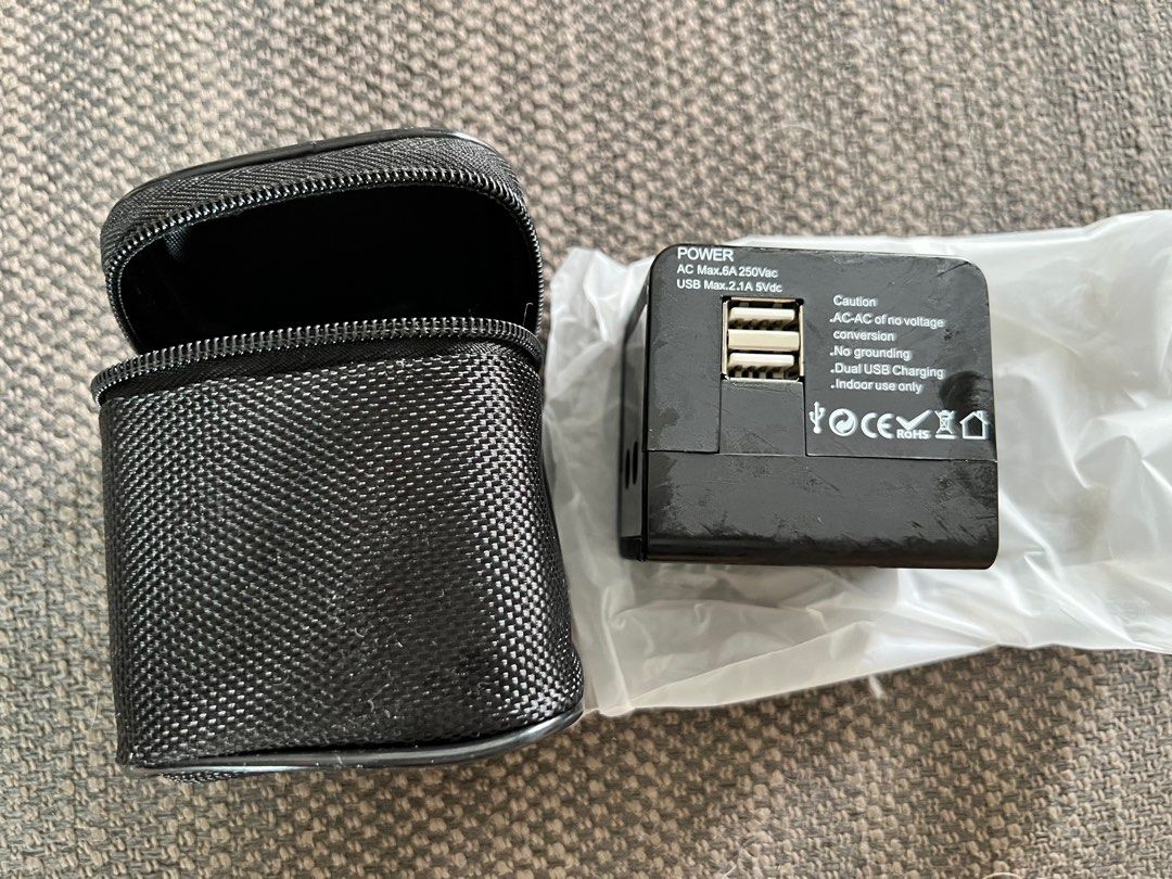 Universal travel adapter with 2 USB ports and storage pouch, Men's ...