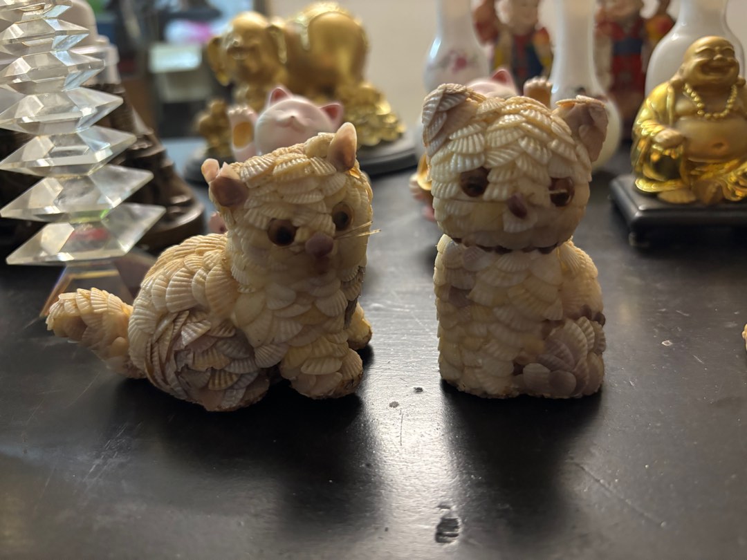A pair of very cute handicrafts, cats made from seashells, are ...