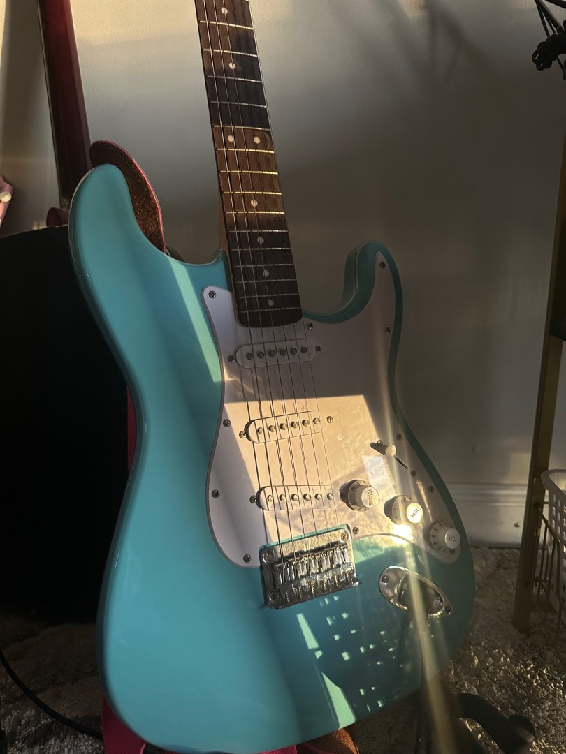 SQUIER BY FENDER STRATOCASTER IN TROPICAL TURQUOISE get all with amplifier,stand, strap and cord ...