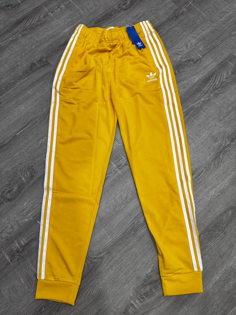 Adidas SST Trackpant Yellow, Men's Fashion, Bottoms, Joggers on Carousell