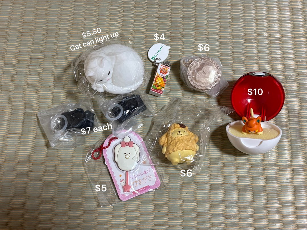 Assorted gachapons (Nikon camera miniature, Neko, canmake miniature ...