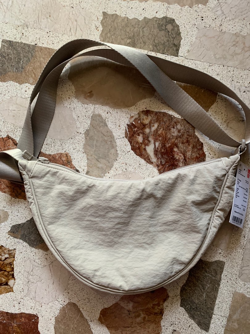 Uniqlo round mini dumpling bag beige, Women's Fashion, Bags & Wallets ...