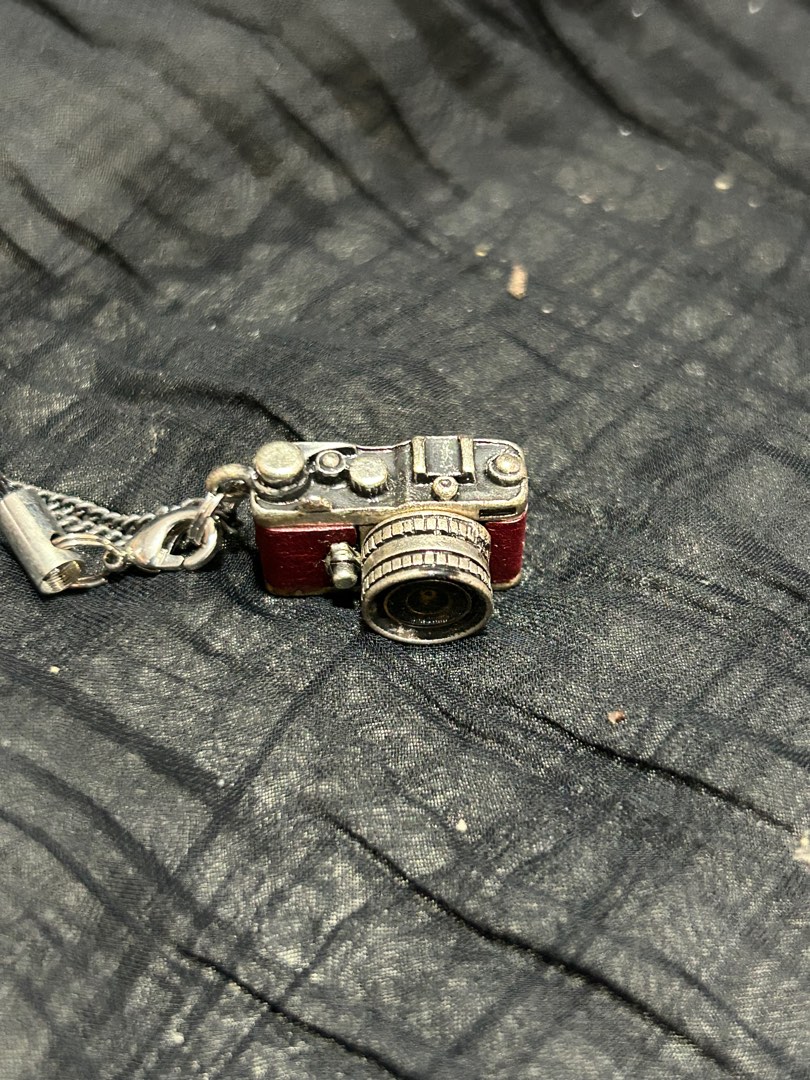 miniature vintage camera, with detailed features like a lens, buttons ...