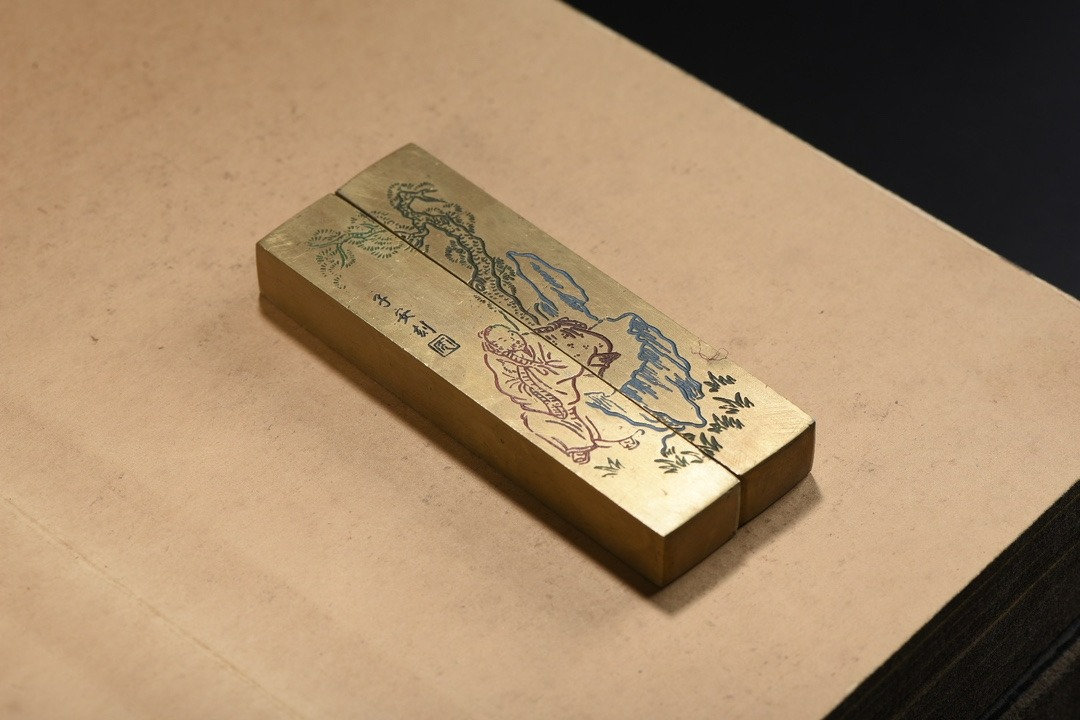 A pair of bronze rulers with figures carved on them, from an old ...