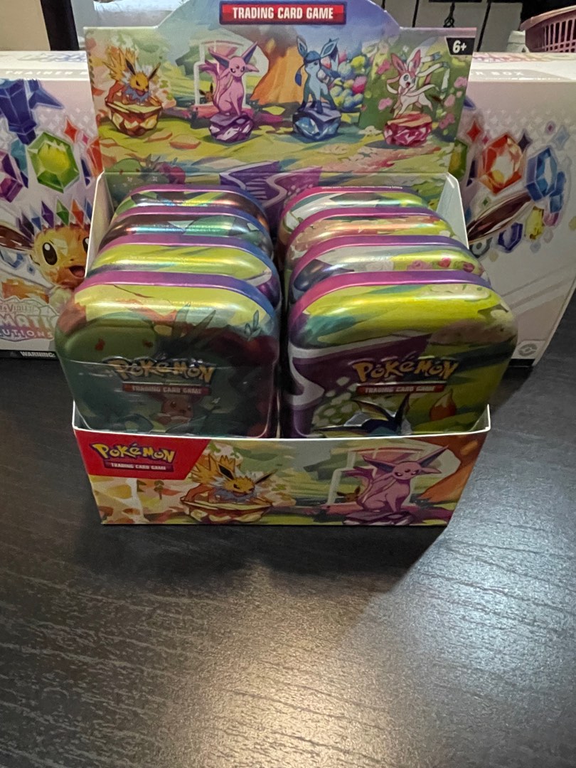 Prismatic evolution tins (empty), Hobbies & Toys, Toys & Games on Carousell