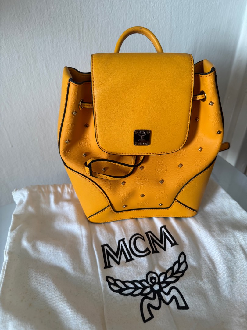 MCM Coated Canvas Monogram Studded Mini Claudia Backpack in Yellow ...
