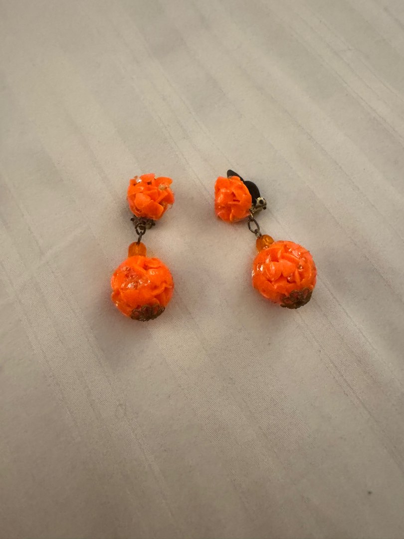 These are vintage celluloid floral earrings, likely dating from the ...